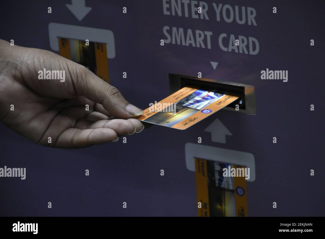 A commuter checking his Smart Card to check balance amount in a Metro ...