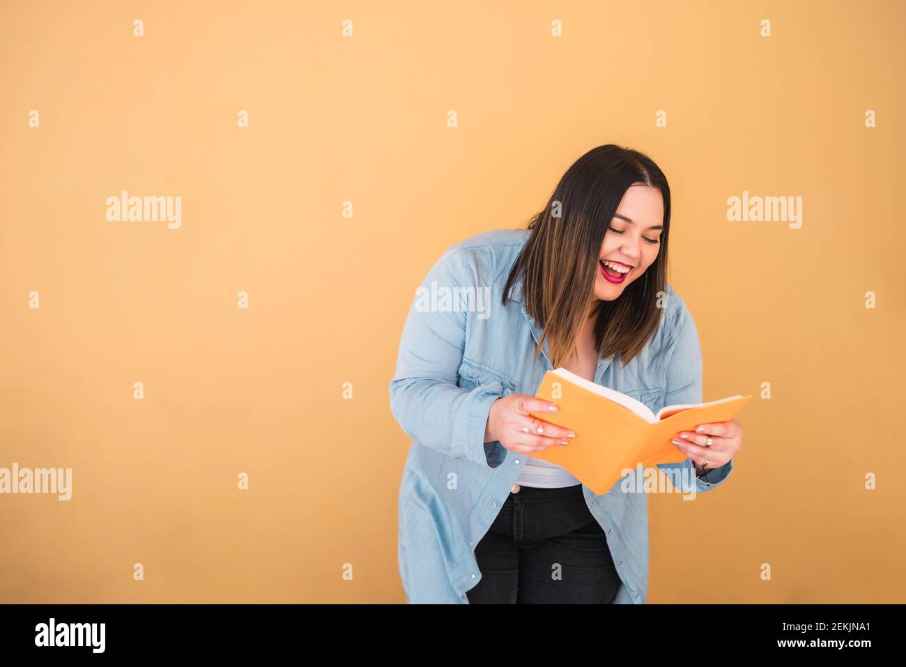 Young plus size woman reading a book Stock Photo - Alamy