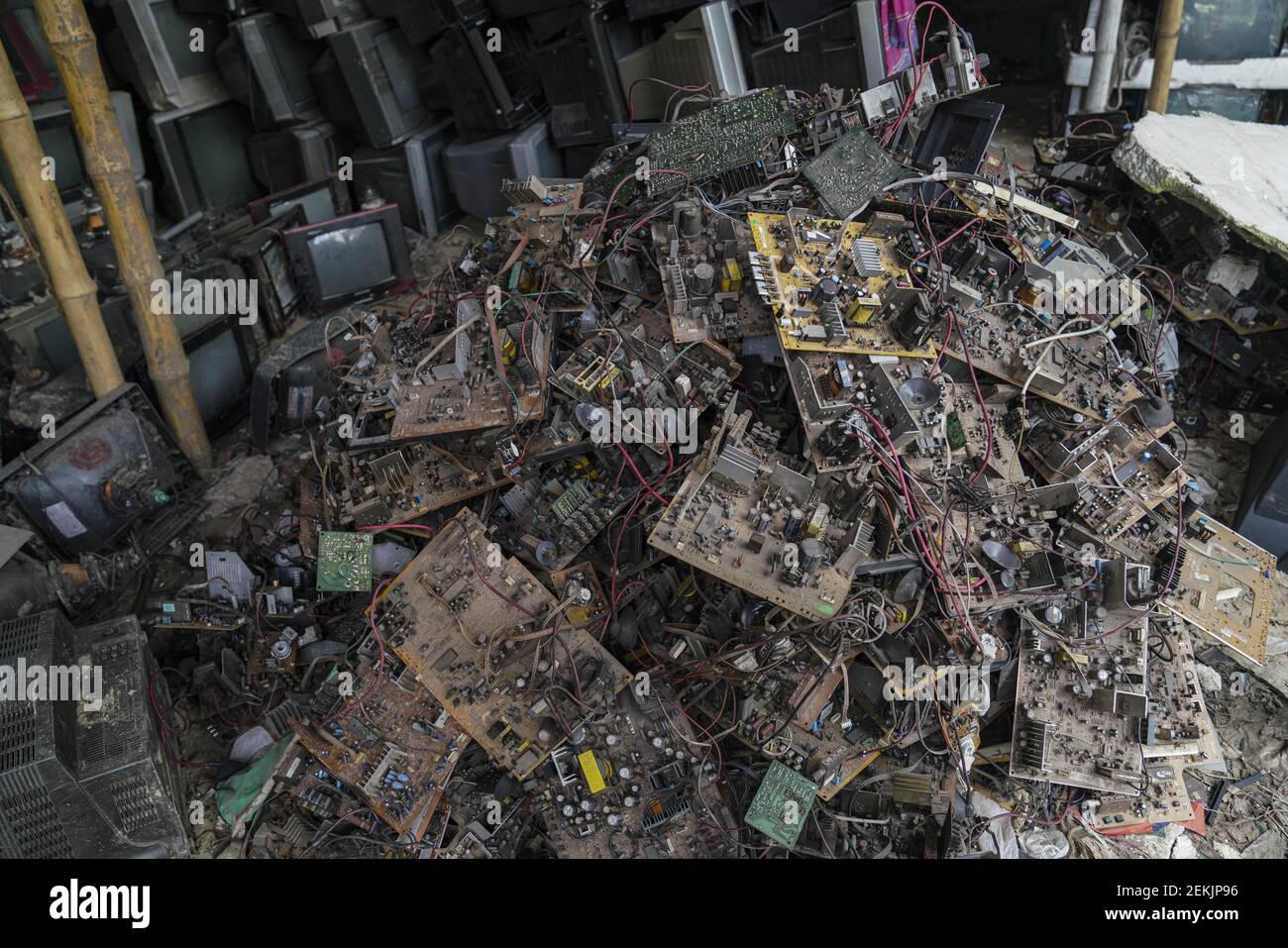 Old TV components are discarded inside at a TV recycling scrap yard in ...