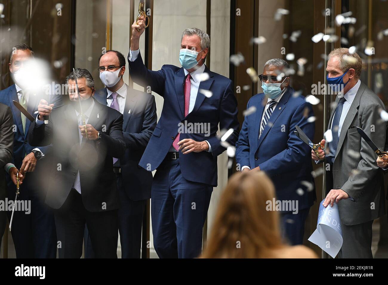 New York City Mayor Bill de Blasio (center) celebrates after cutting ...