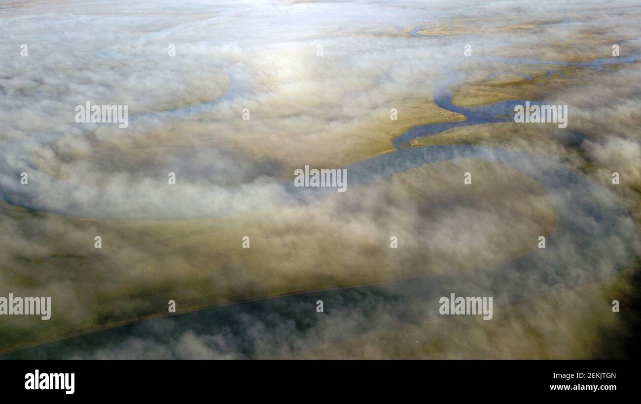 The beautiful advection fog above the Bayanbulak Grassland in ...