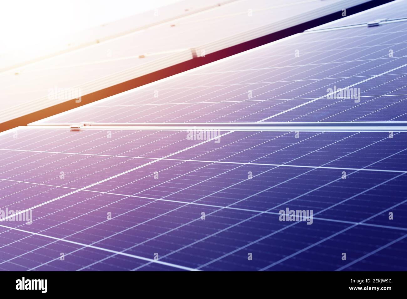Solar panels on house roof at sunset against blue sky. Solar energy ...