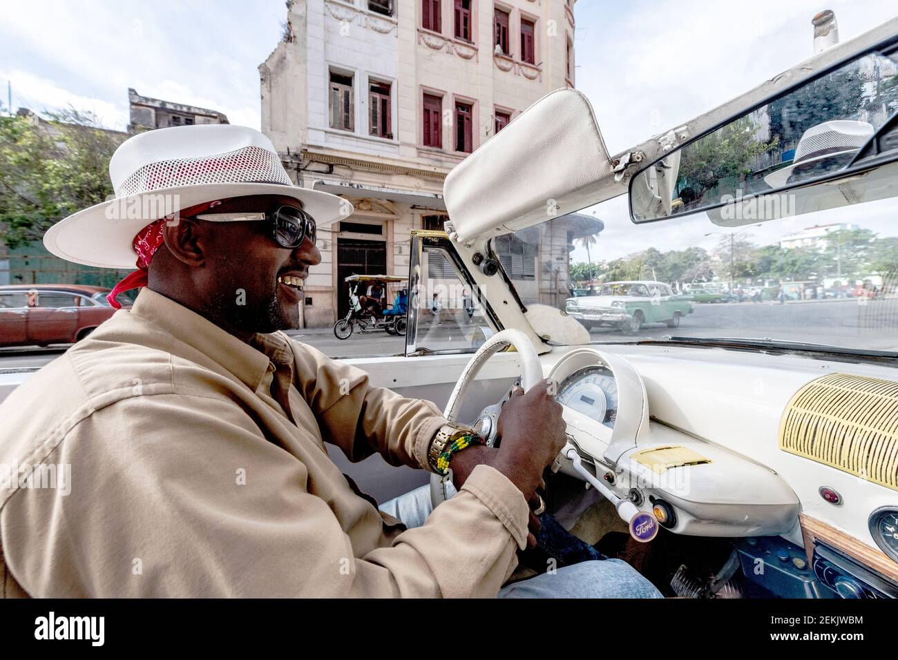 Driver of an old vintage American convertible car taxi in Havana, Cuba ...