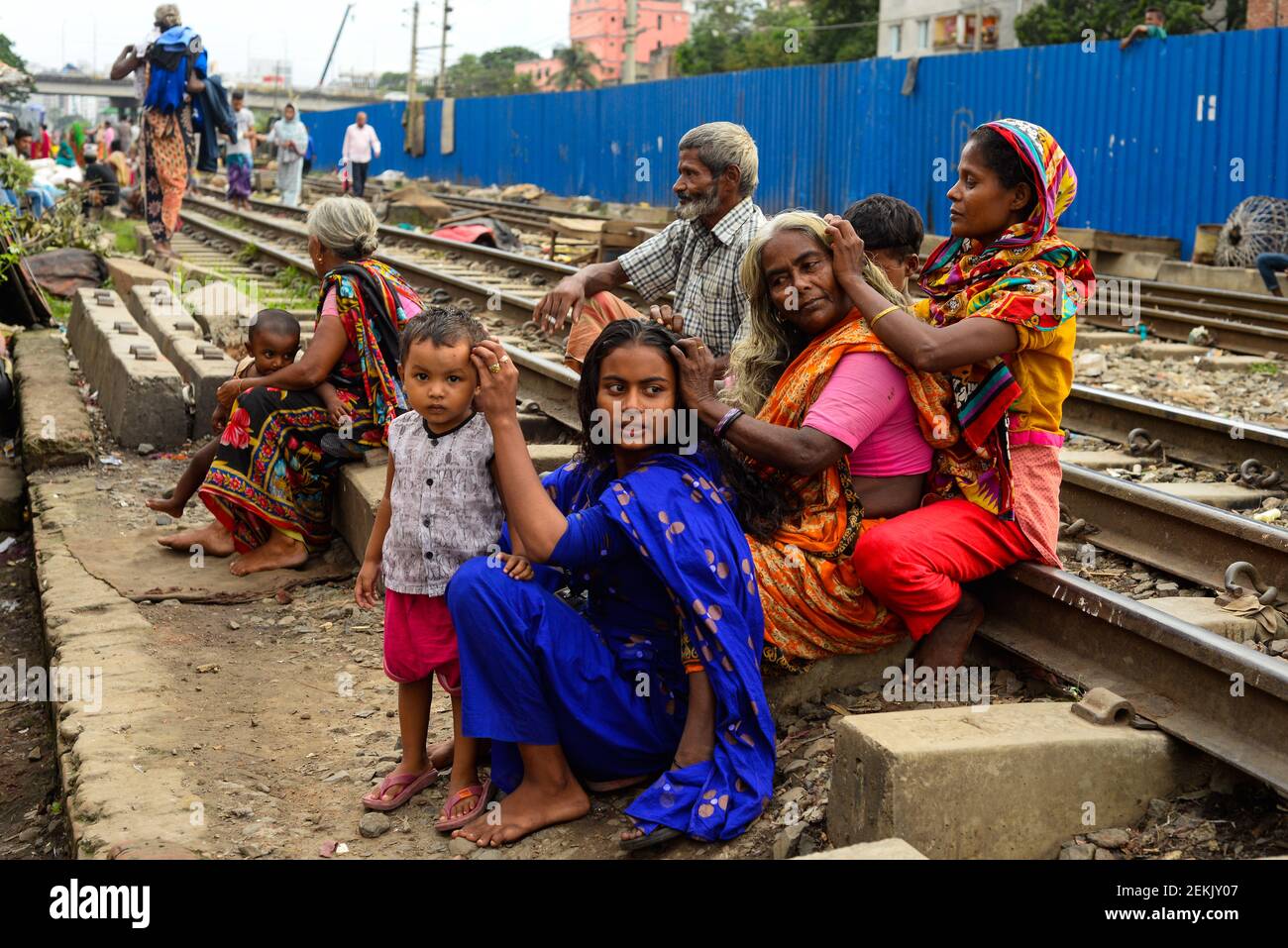 The residents of the slum beside the Tejgaon rail line seen riskily ...