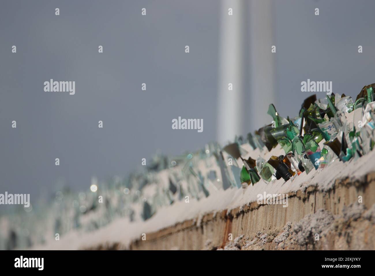 A wall's top was filled with hundreds of meters of glass shards to ...