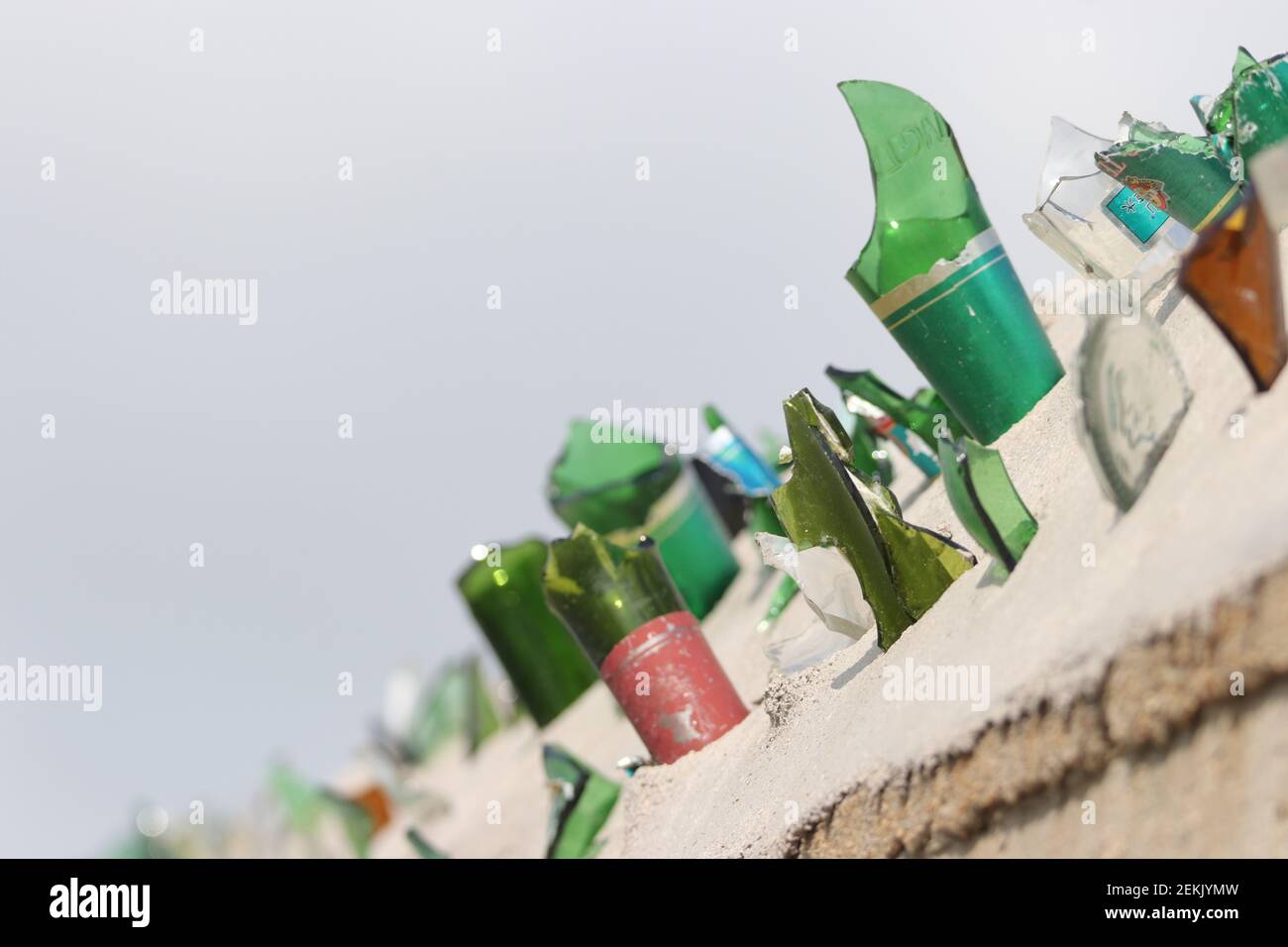 A wall's top was filled with hundreds of meters of glass shards to ...