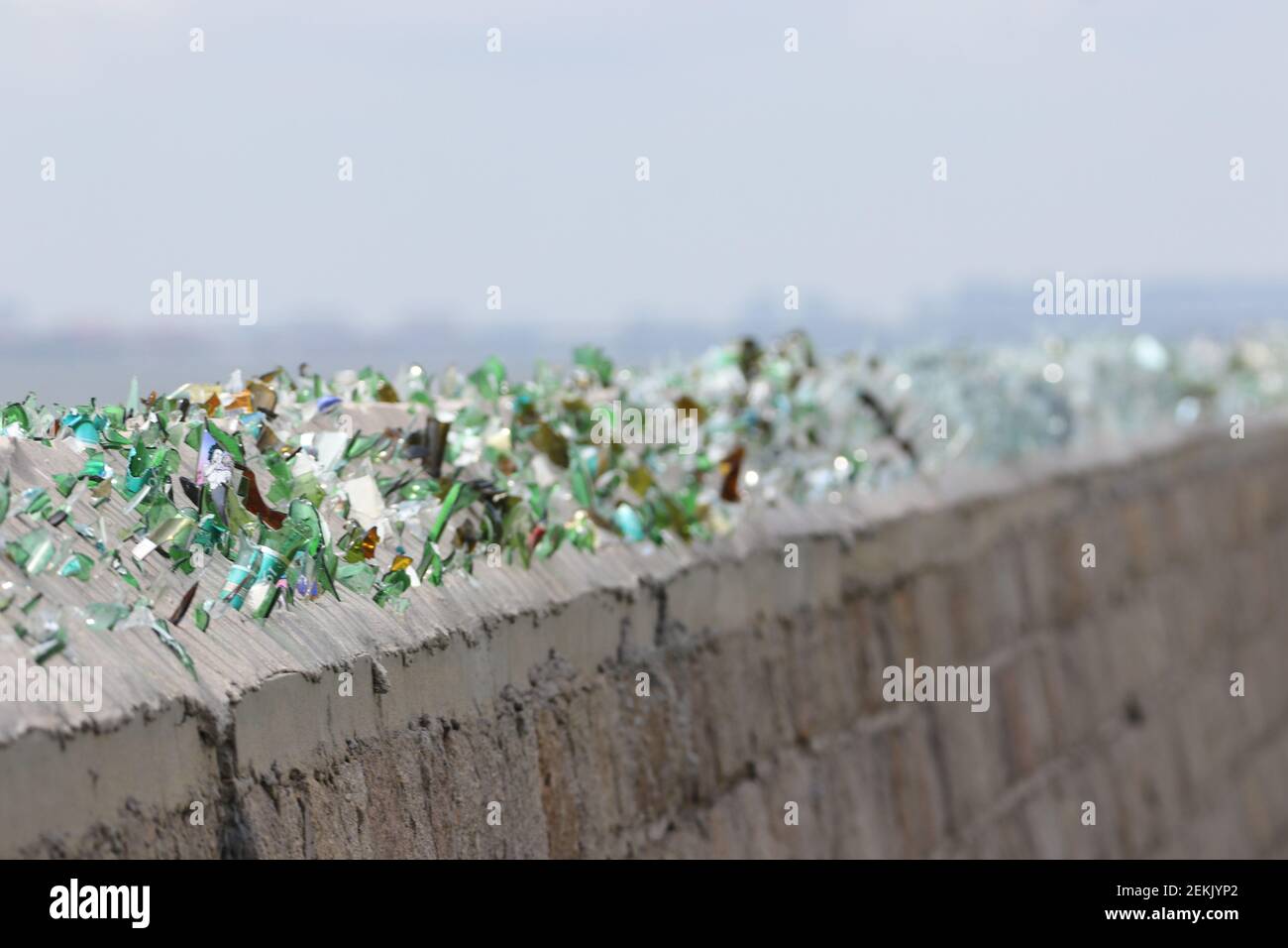 A wall's top was filled with hundreds of meters of glass shards to ...