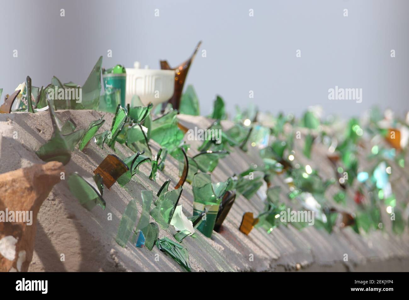 A wall's top was filled with hundreds of meters of glass shards to ...
