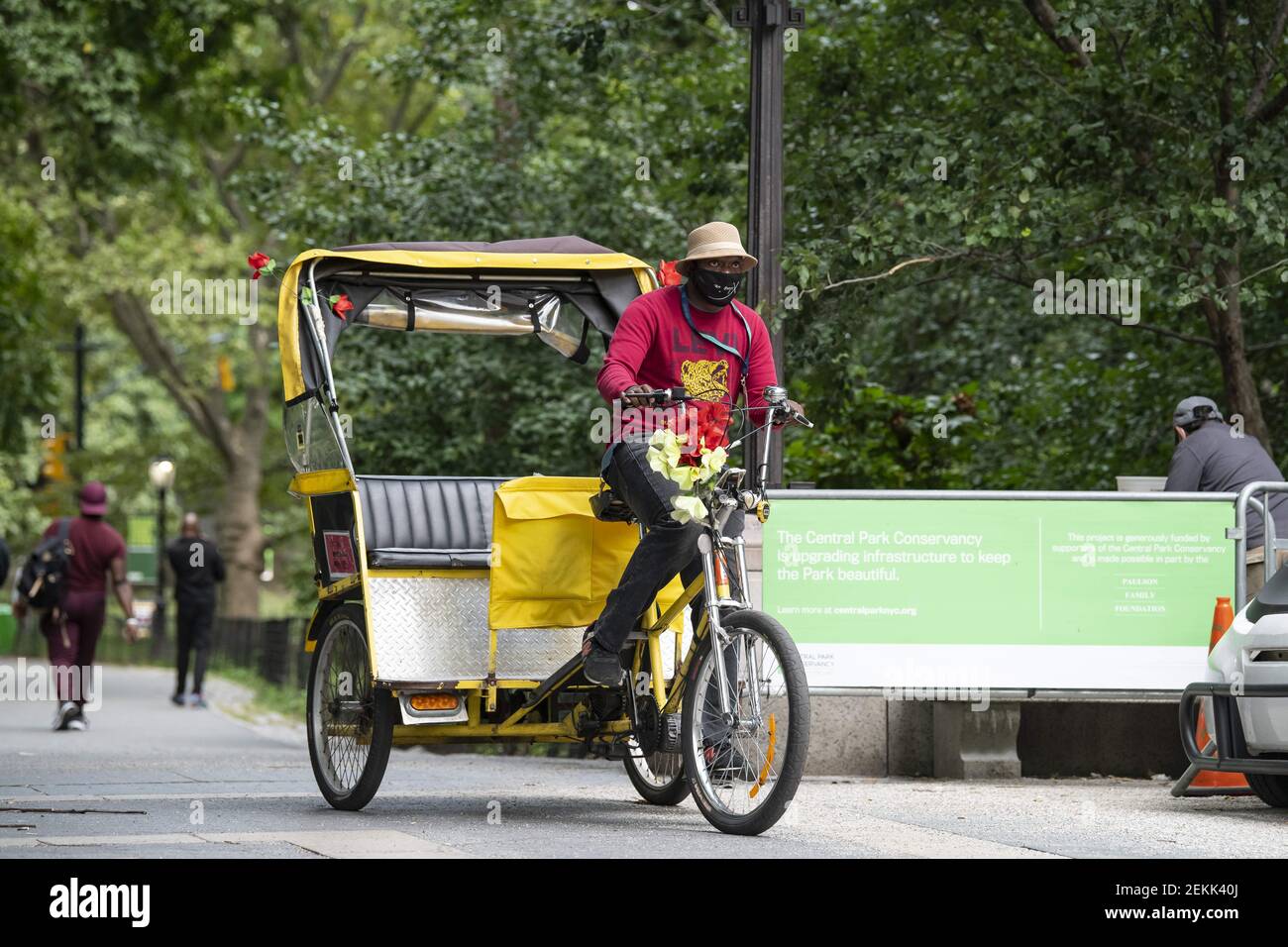 A New York Pedicab driver peddles through Central Park wearing a PPE ...