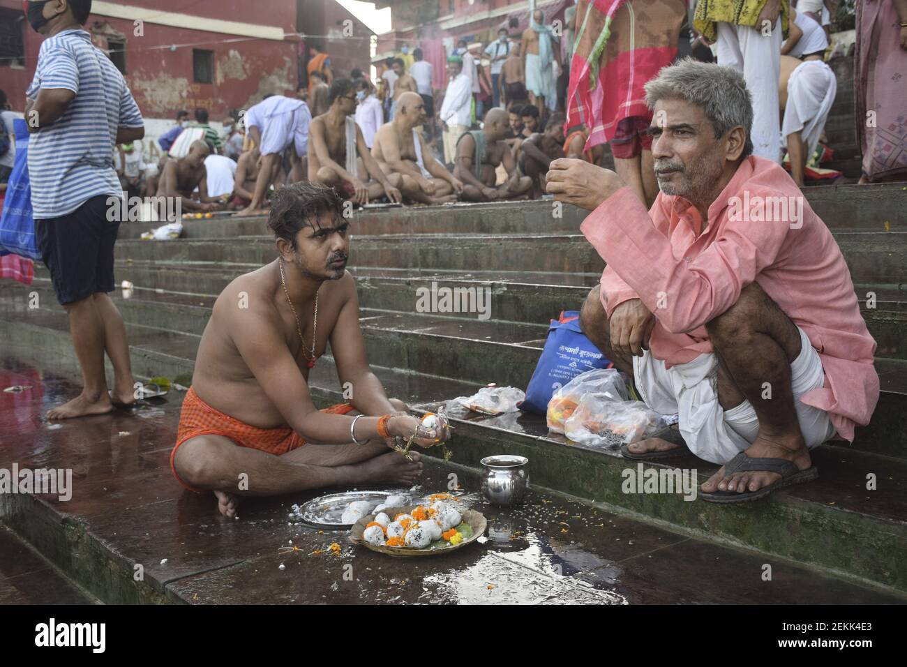 A Hindu devotee is performing mahalaya rituals rituals at ganga ghat on ...