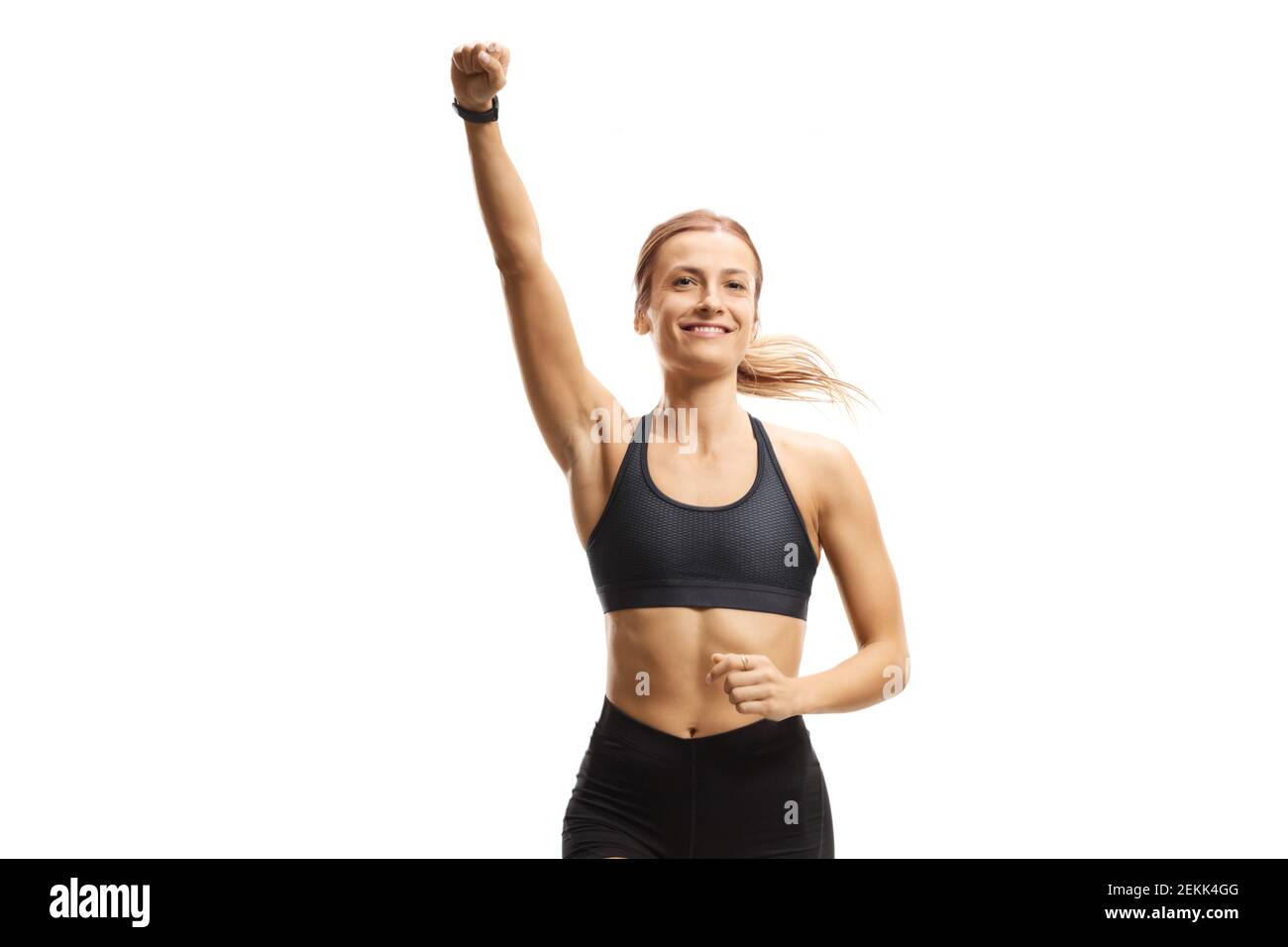 Young woman running towards the camera with raised arm isolated on ...