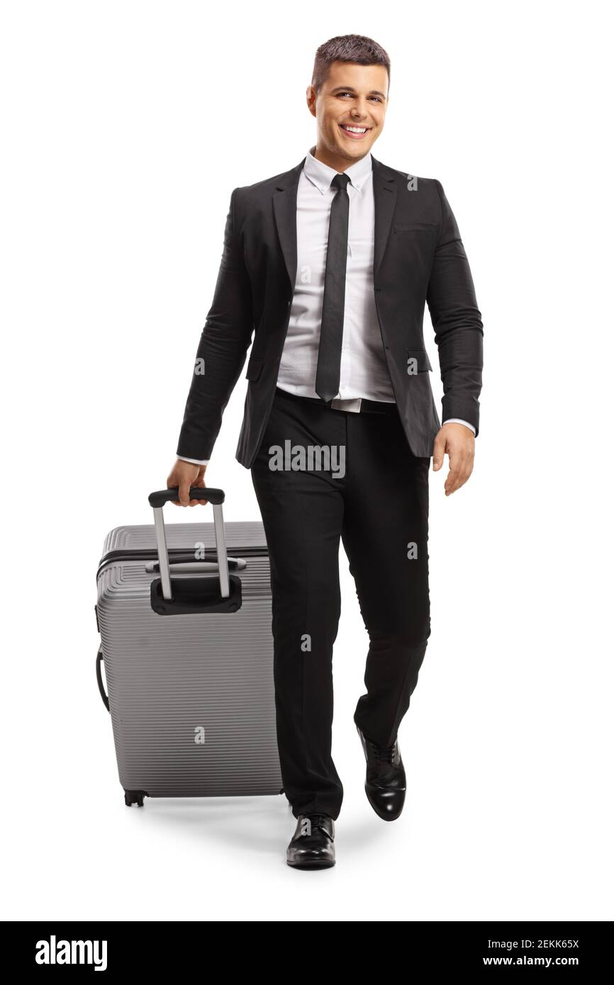 Full length portrait of a young man in a suit and tie walking towards ...