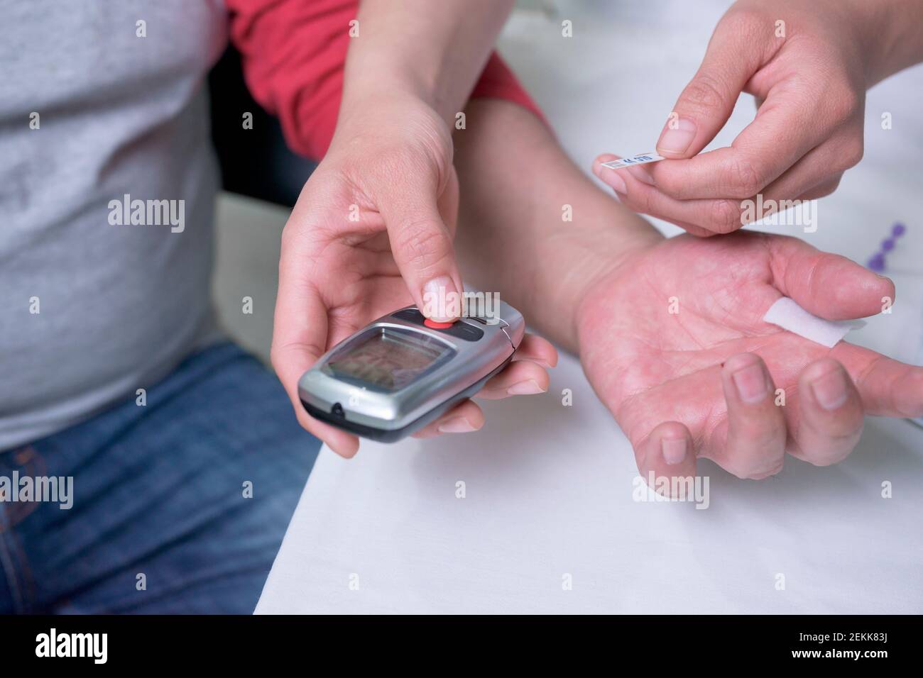 It shows how to do a glucose test with a glucometer Stock Photo - Alamy