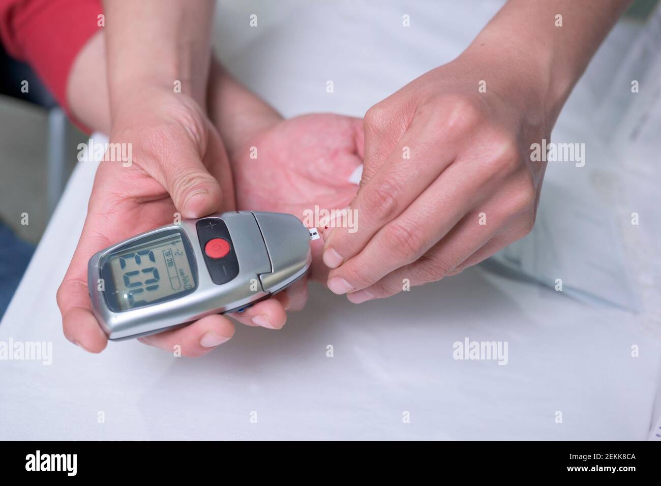 It shows how to do a glucose test with a glucometer Stock Photo - Alamy
