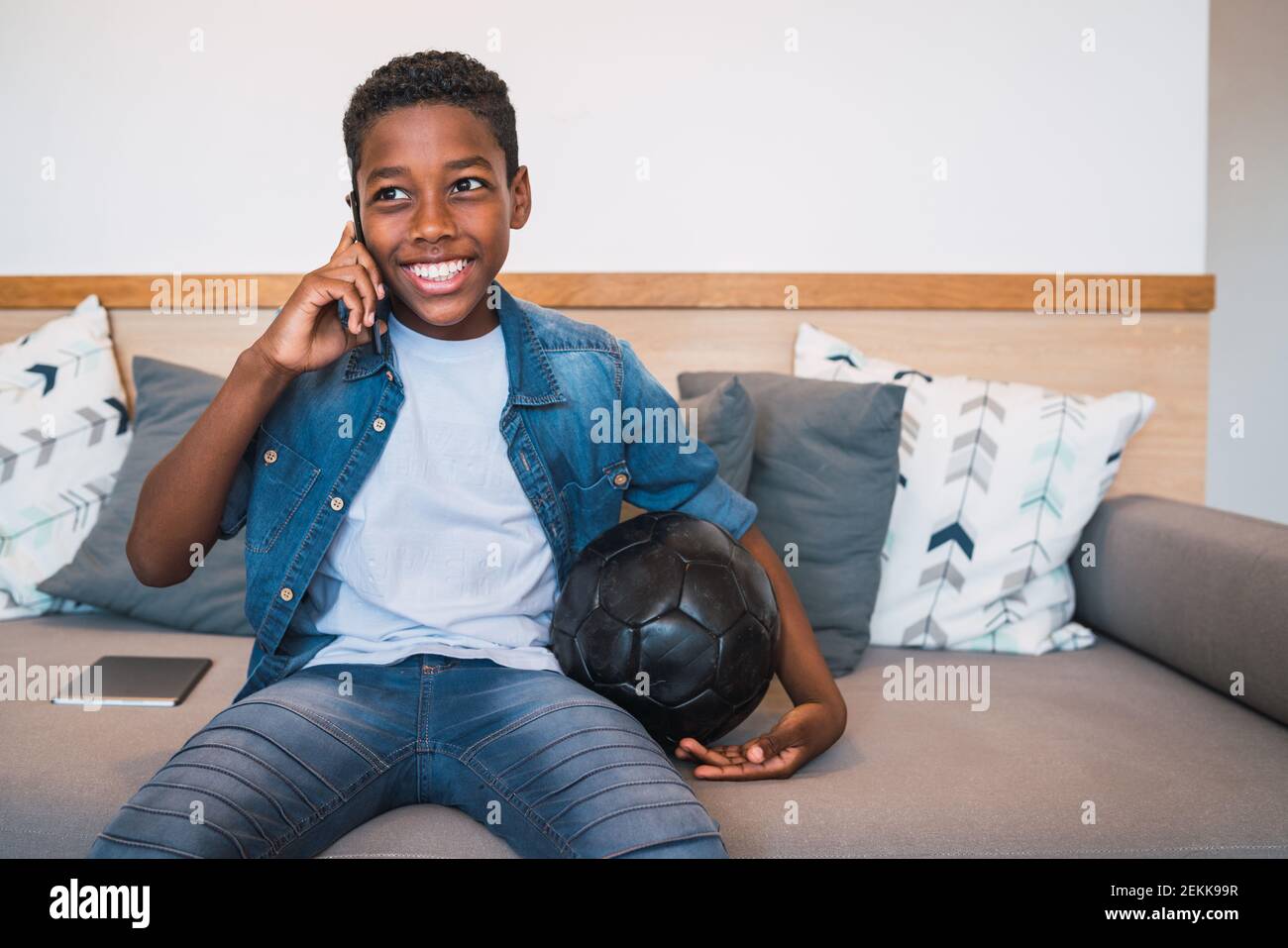 Little boy talking on the phone at home Stock Photo - Alamy