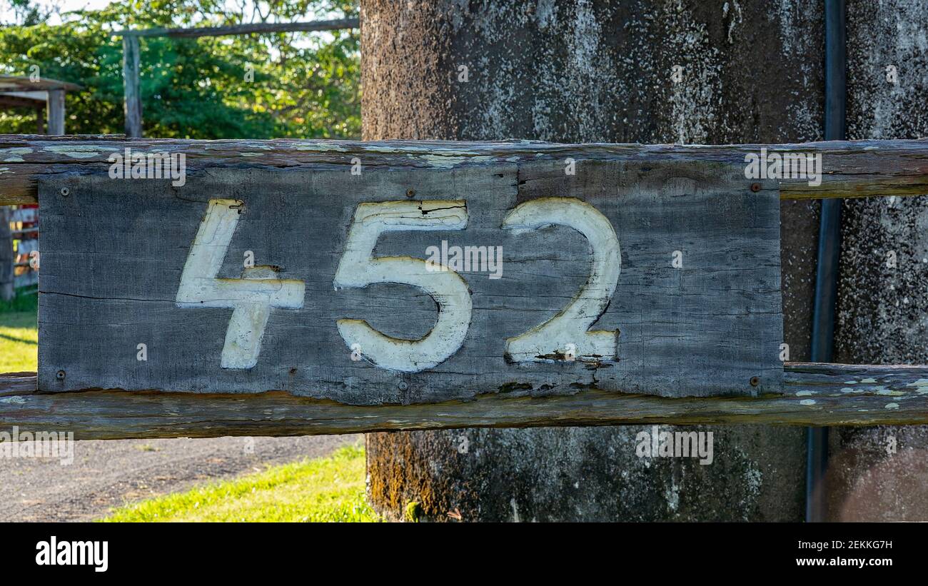 A timber sign with the property number etched into the wood Stock Photo ...