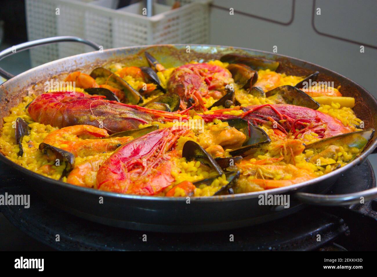 Image of a seafood paella being made in a gas paella pan in a home ...