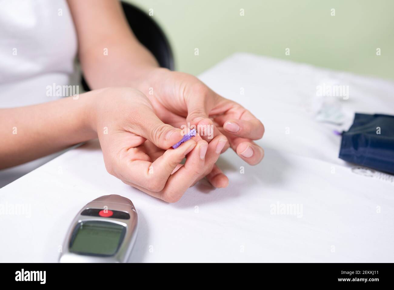 shows how to do a glucose test with a glucometer at home Stock Photo ...