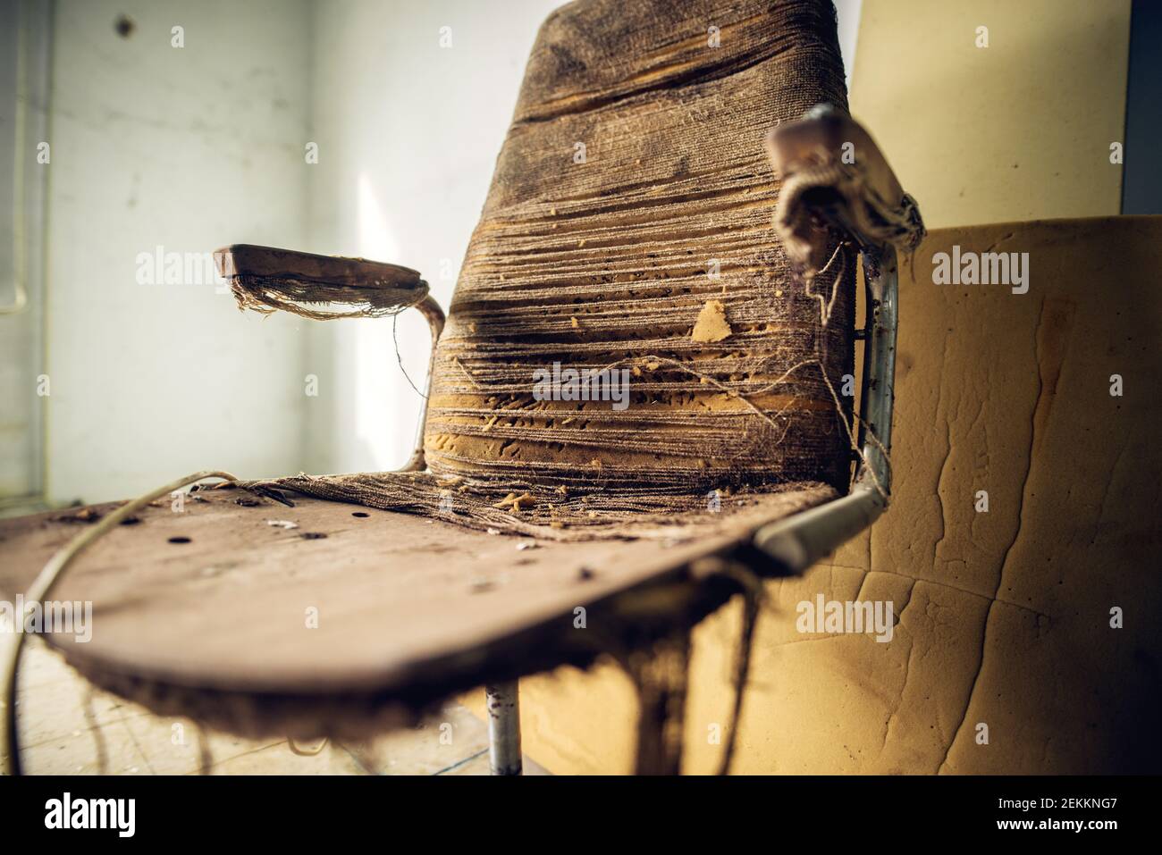 Close up focus view of ruined old forgotten armchair in the abandoned ...