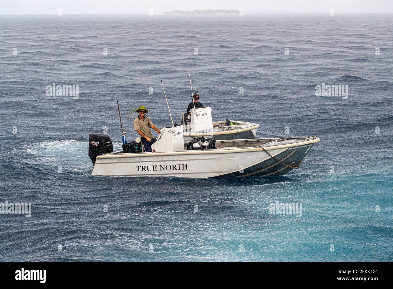 Boat on the ocean in the rain Stock Photo - Alamy