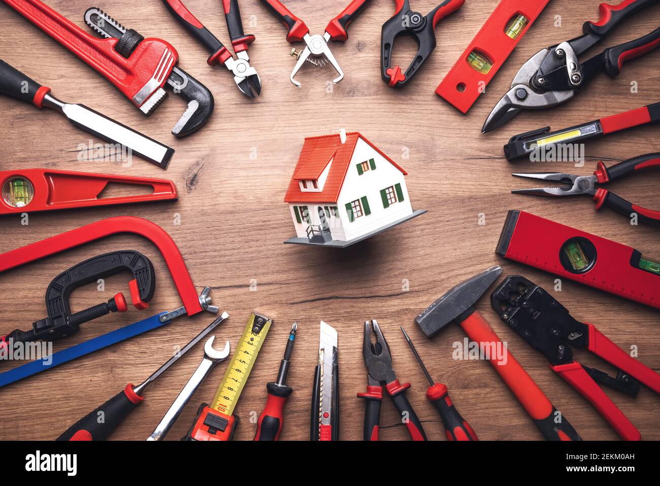 Assorted work tools and house on wooden background Stock Photo - Alamy