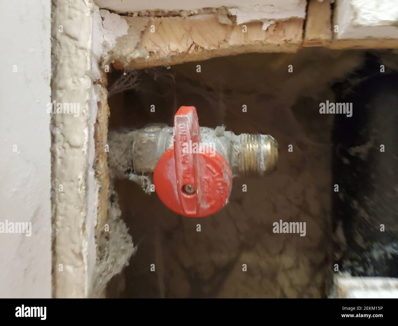 Close-up of natural gas shutoff or appliance connection valve in ...