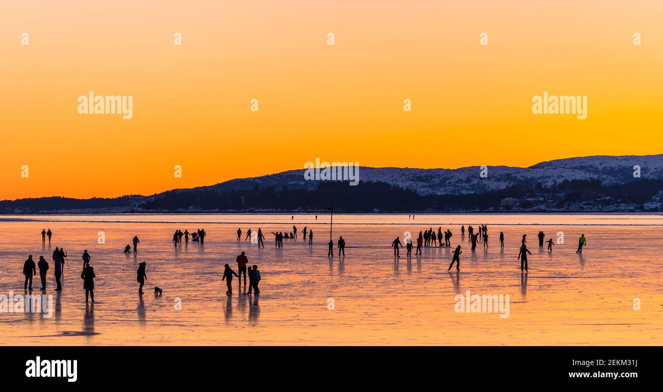 People skating on the ice of a fjord near Bergen, Norway Stock Photo ...
