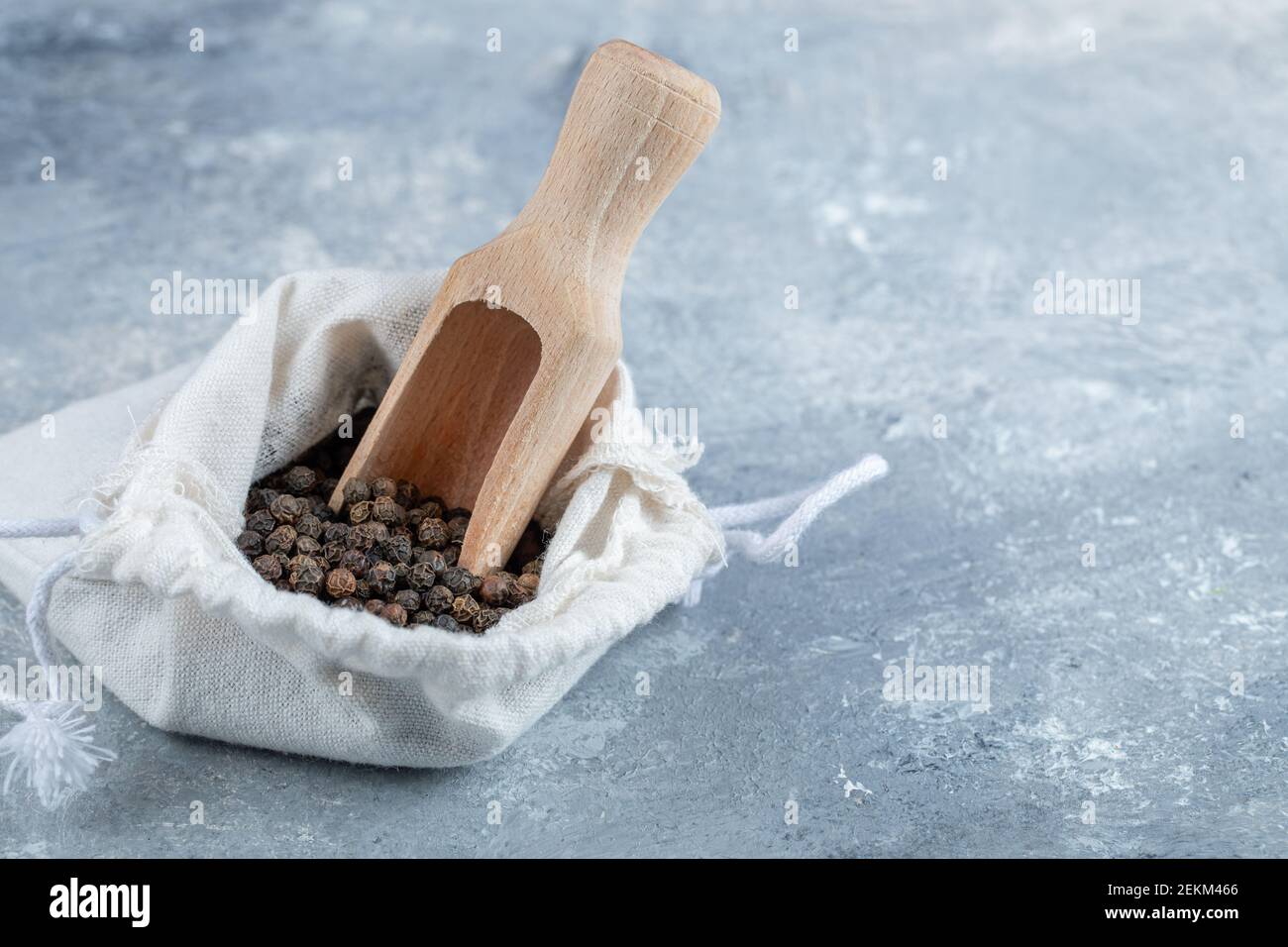 A white sack full of dried pepper on a gray background Stock Photo - Alamy
