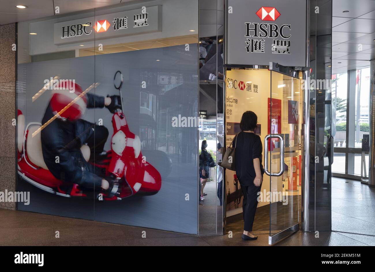 A woman walks in the British multinational banking and financial ...