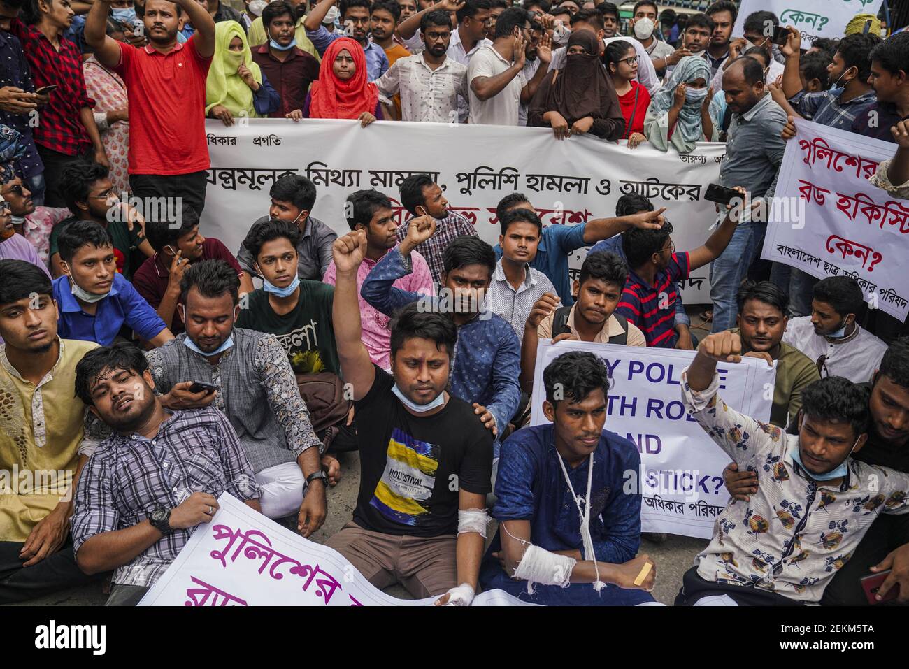 Protesters hold a banner and placards during the demonstration ...