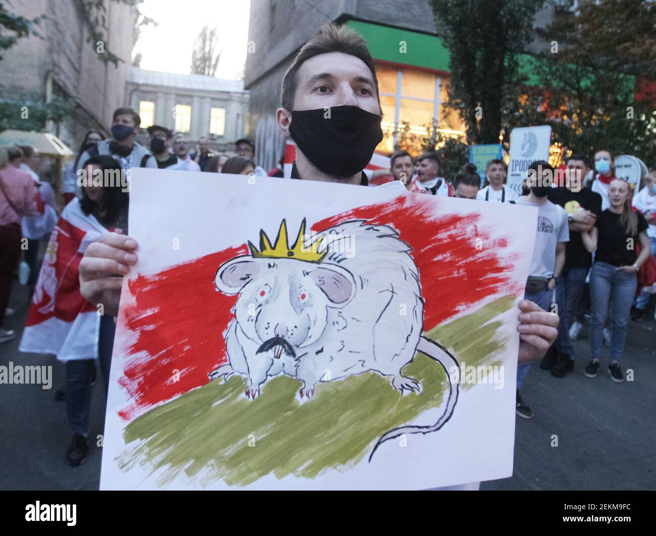 A protester wearing a face mask holds a placard during the ...