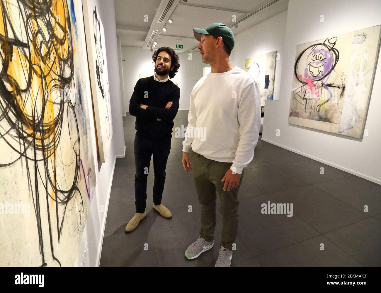 George Morton-Clark discusses one of his works with a visitor during ...