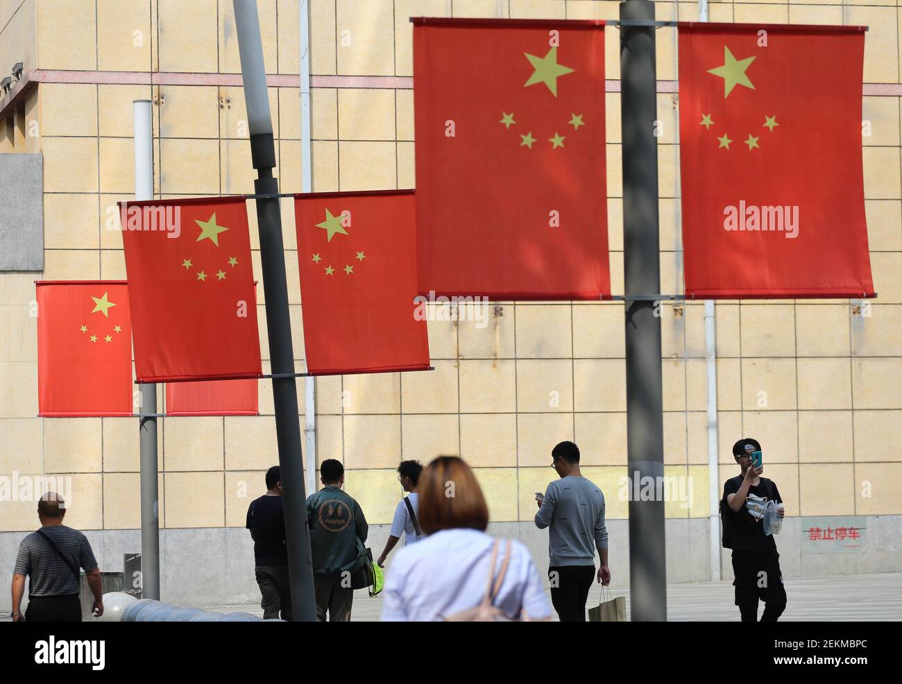 National flags of China are hung in the street light, welcoming the ...