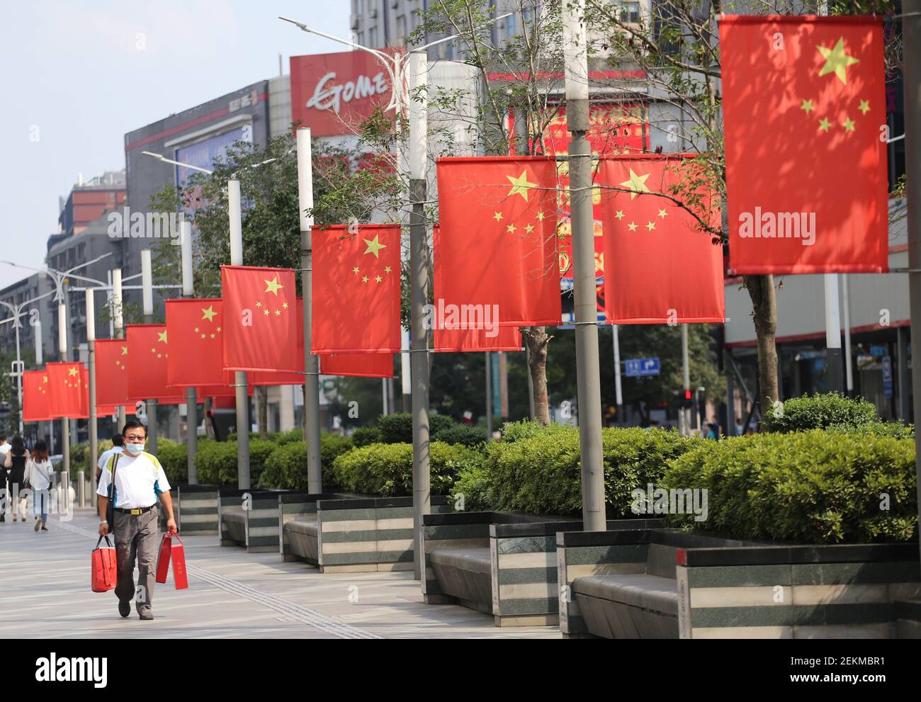 National flags of China are hung in the street light, welcoming the ...