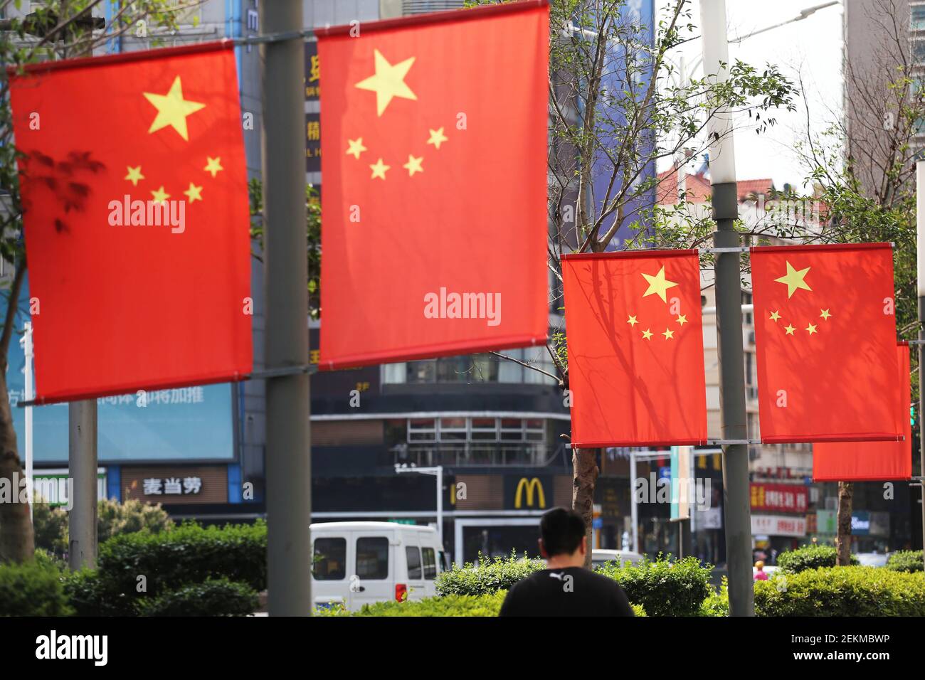 National flags of China are hung in the street light, welcoming the ...