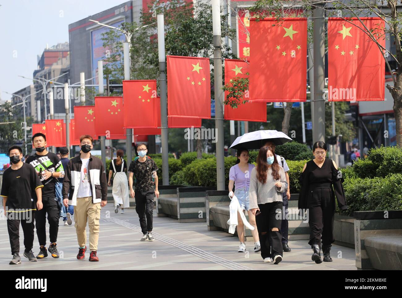 National flags of China are hung in the street light, welcoming the ...