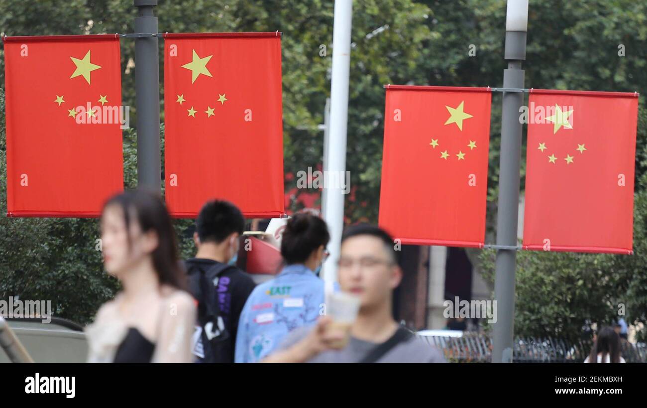 National flags of China are hung in the street light, welcoming the ...