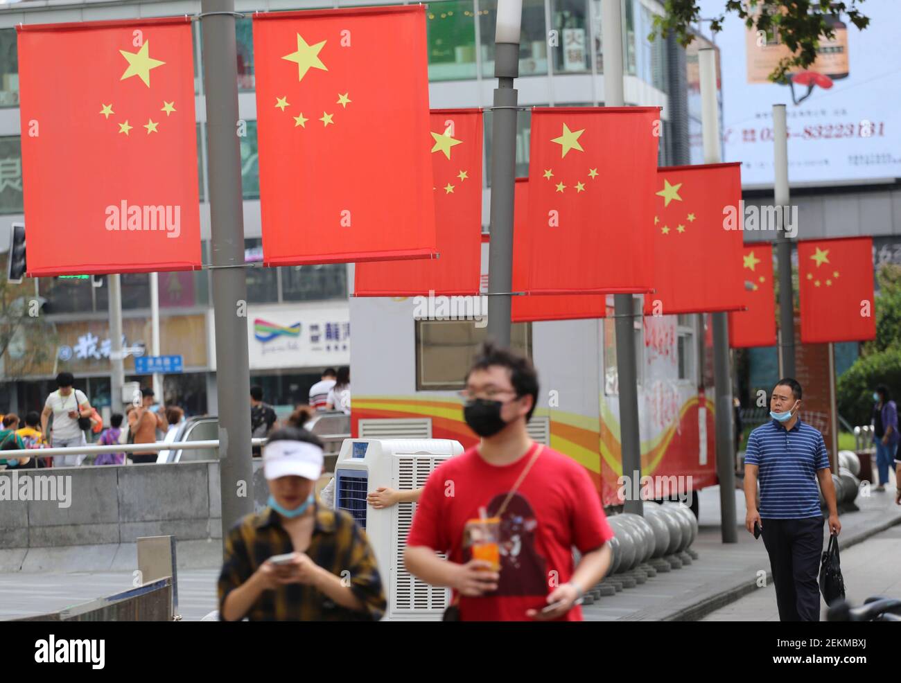 National flags of China are hung in the street light, welcoming the ...