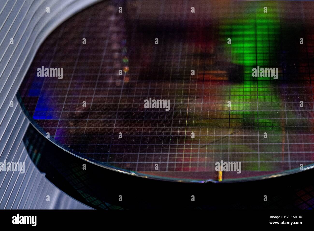 A wafer (a thin slice of semiconductor) seen on display during the ...