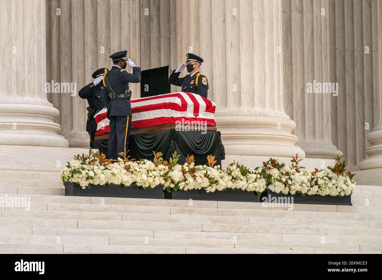 Guards salute the casket of Associate Justice Ruth Bader Ginsburg as it ...
