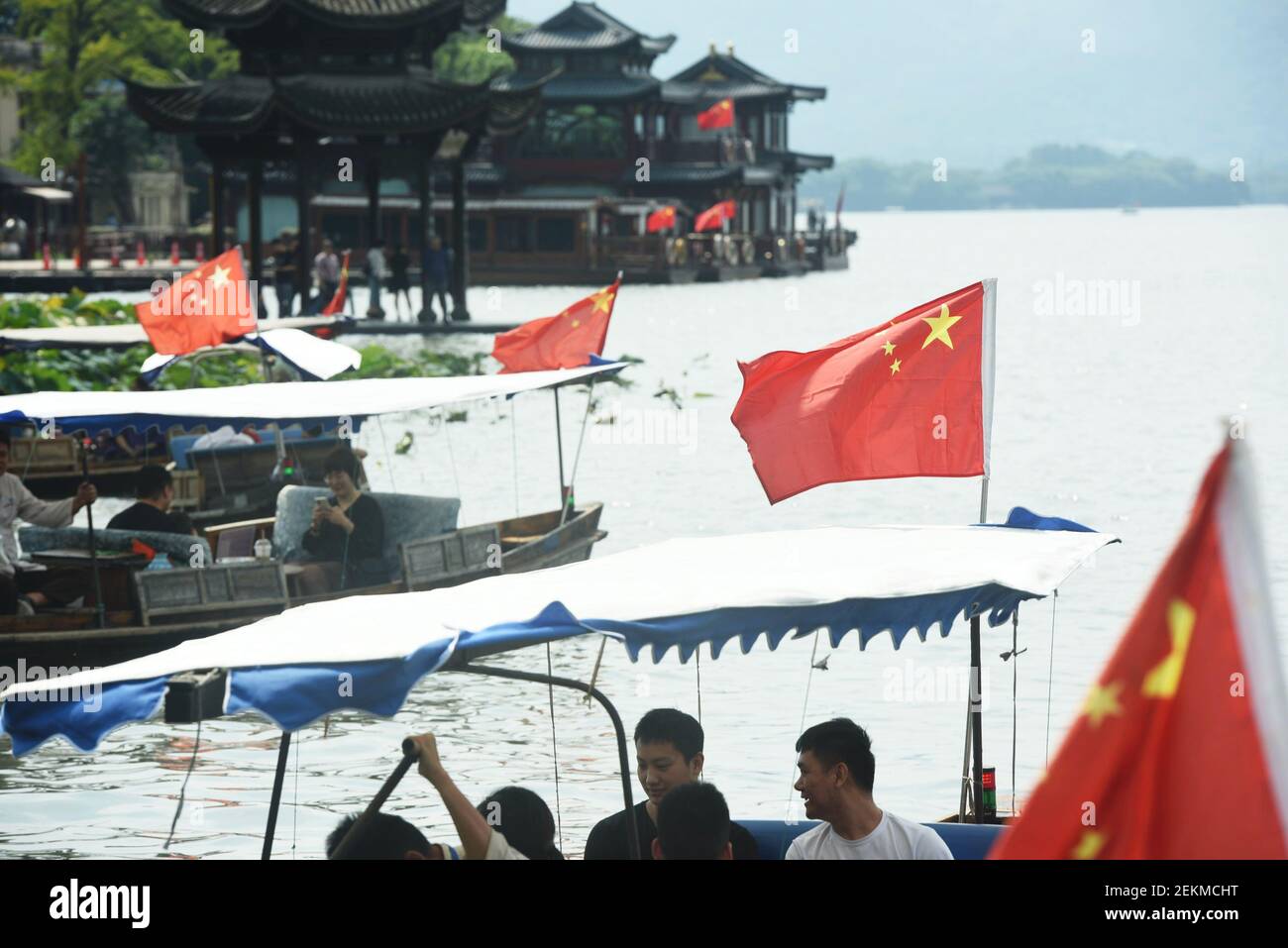 HANGZHOU, CHINA - SEPTEMBER 24, 2020 - Tourists take a boat with five ...