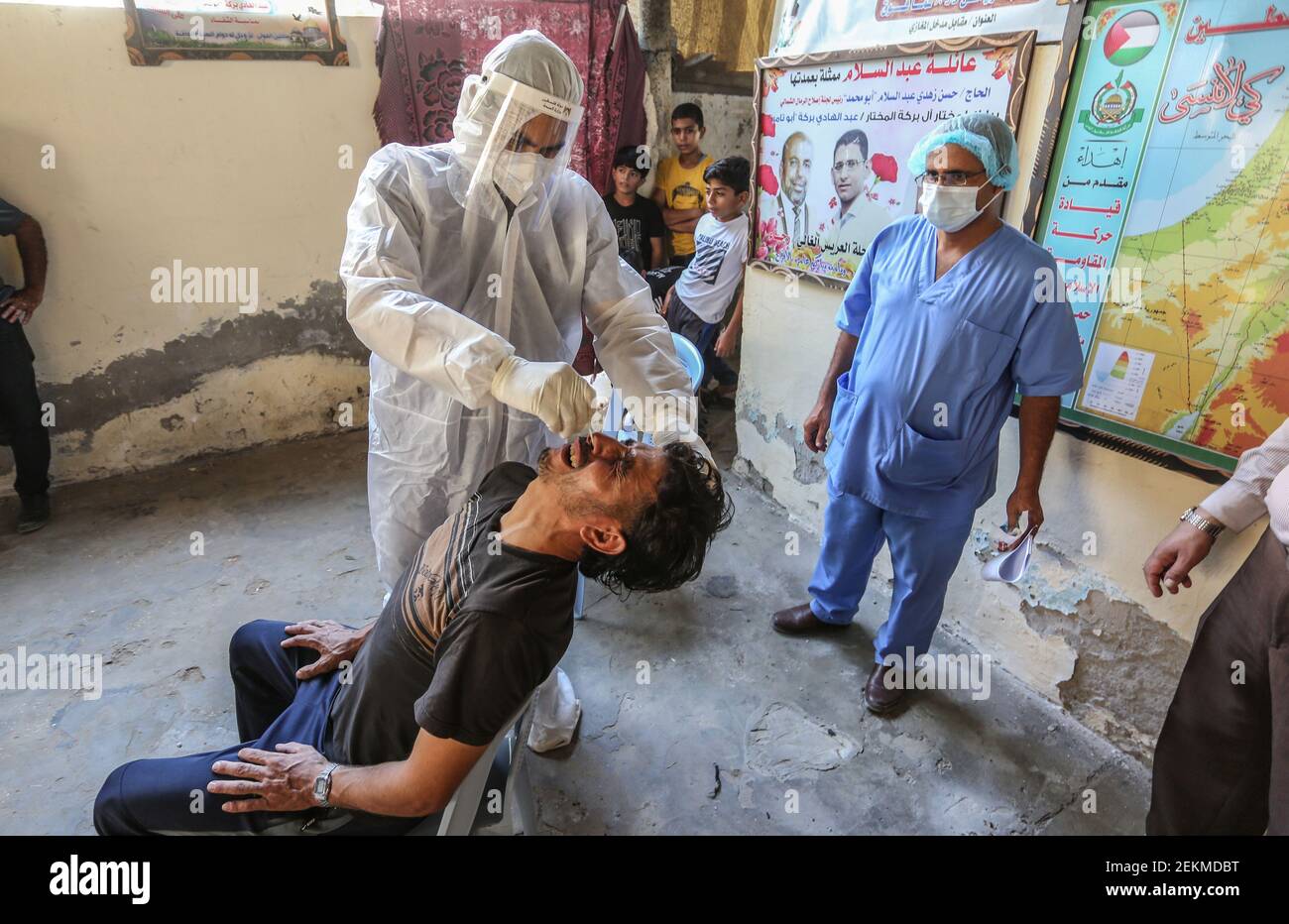 A Palestinian medic from the Infection Control Committee, collects a ...
