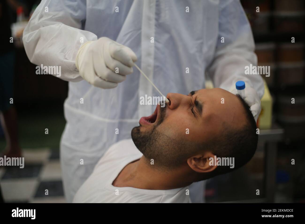 A Palestinian medic from the Infection Control Committee, collects a ...