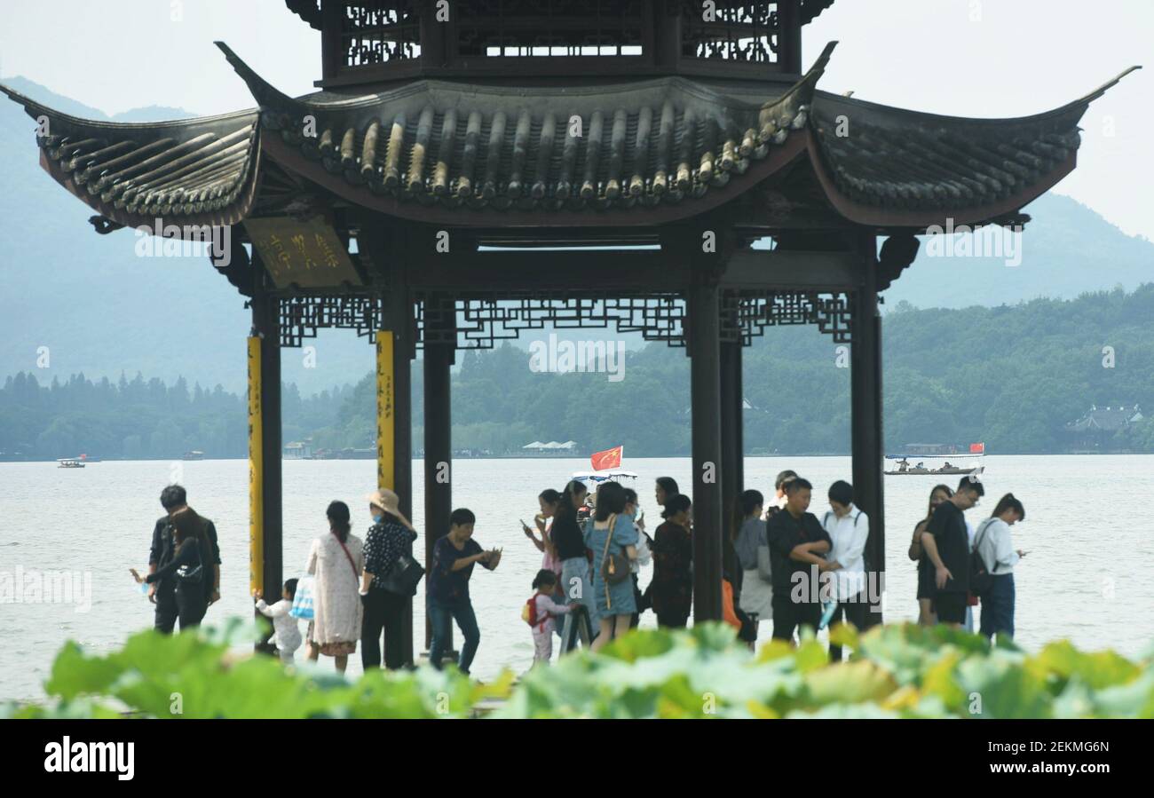 National flags of China fly on the boat in the West Lake, welcoming the ...