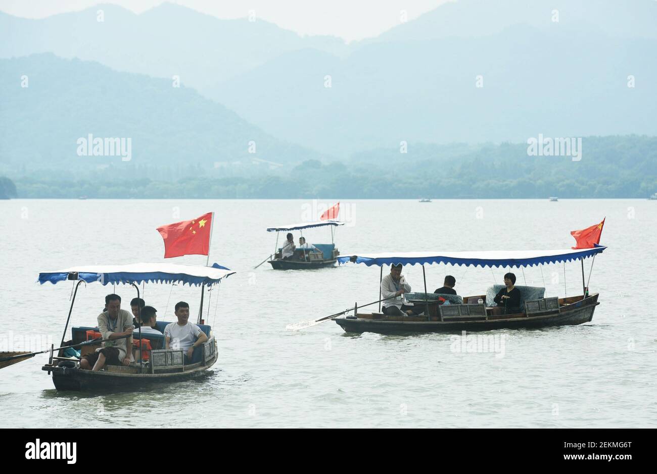 National flags of China fly on the boat in the West Lake, welcoming the ...