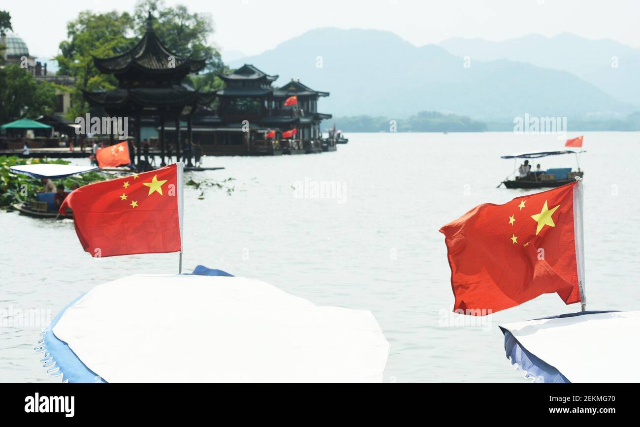 National flags of China fly on the boat in the West Lake, welcoming the ...