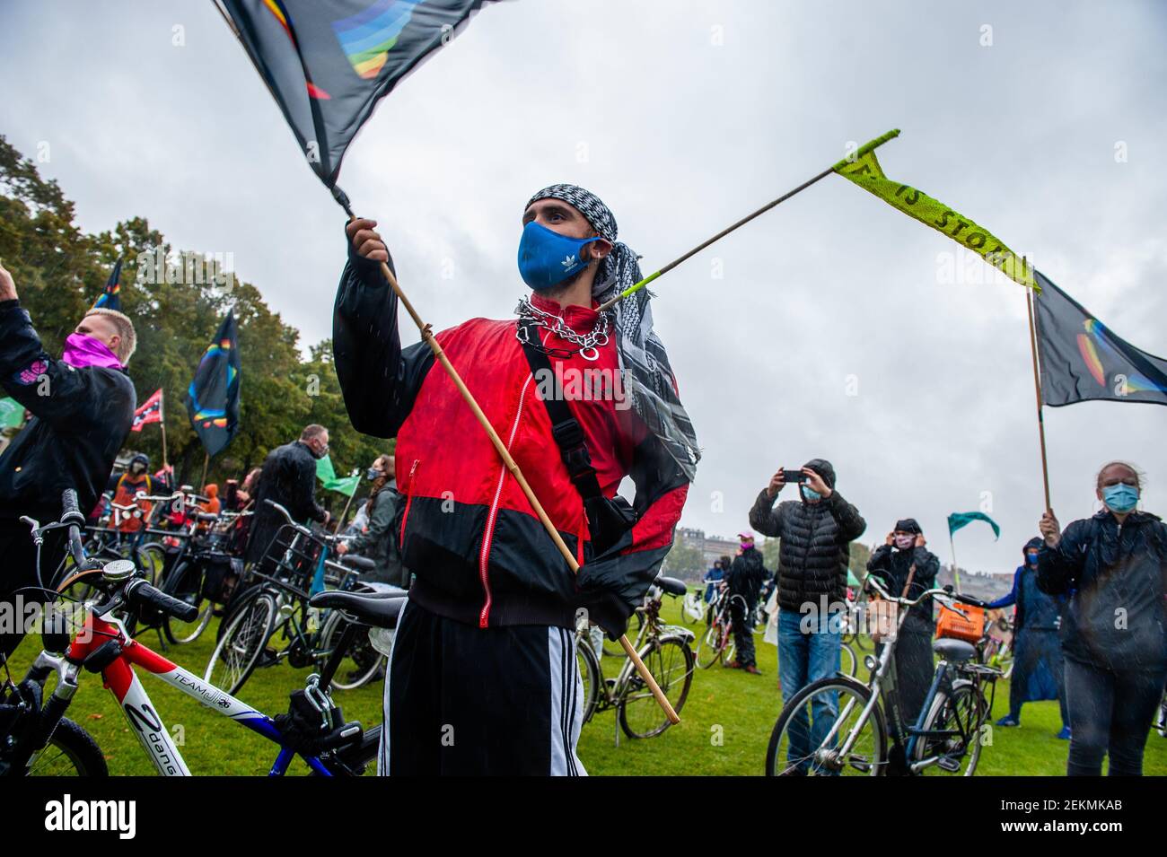 An activist waving a flag standing next to his bike during the global ...