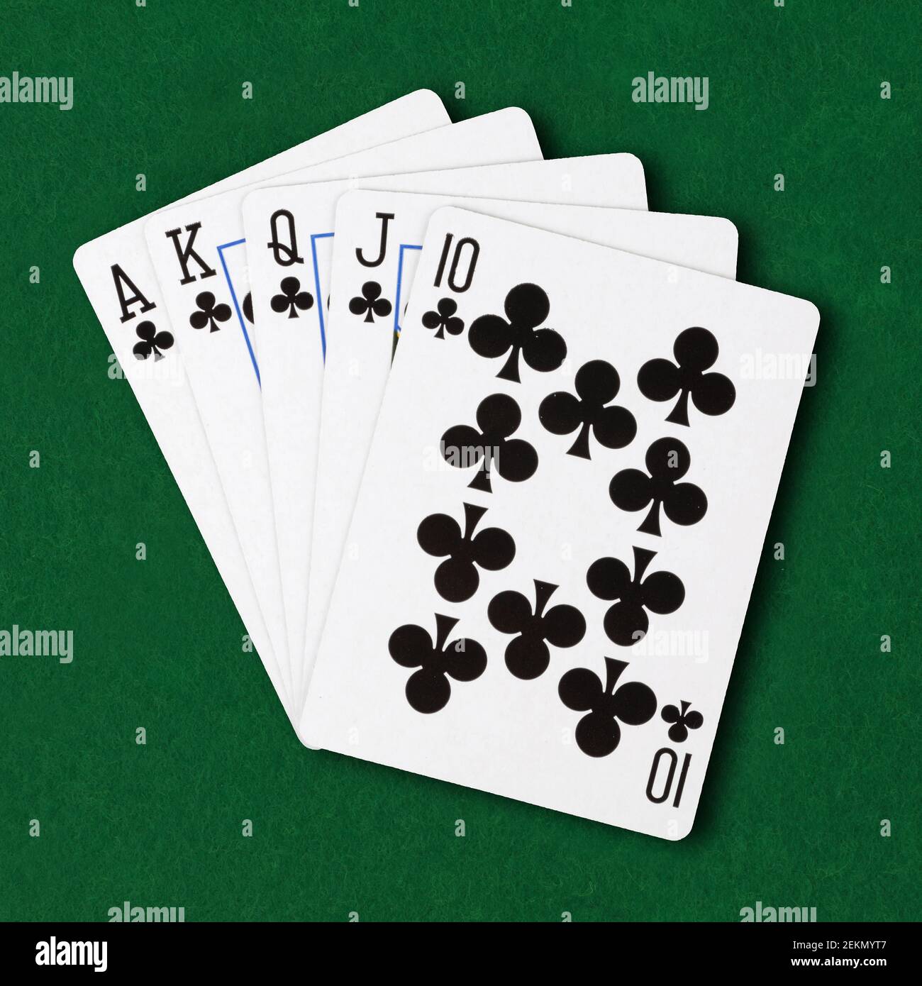 Hand of cards clubs royal flush on green card table cloth winning hand ...