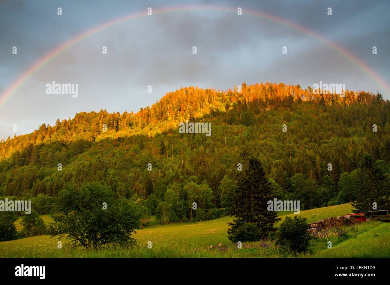 Evening rainbow in front of mountain landscape on the slopes of the ...