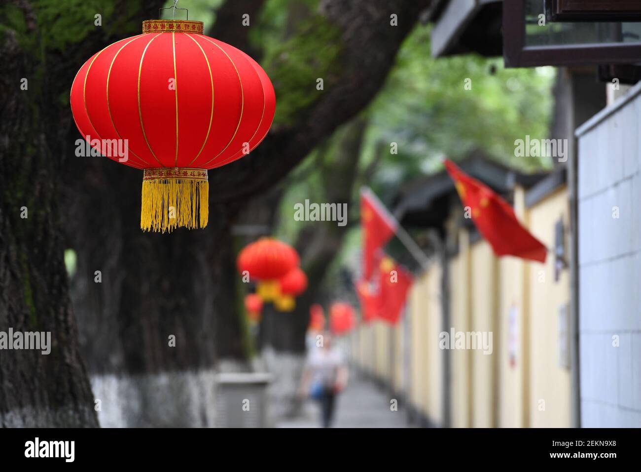 Red lanterns and national flags are seen flying along the Yihe street ...